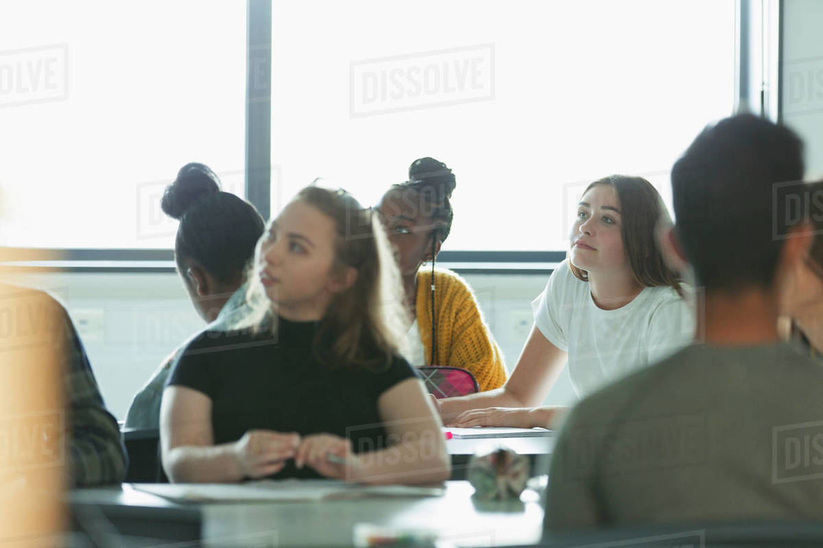 Attentive high school students listening in classroom - Royalty-free ...