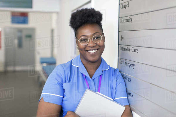Portrait smiling, confident female nurse in hospital corridor - Royalty ...