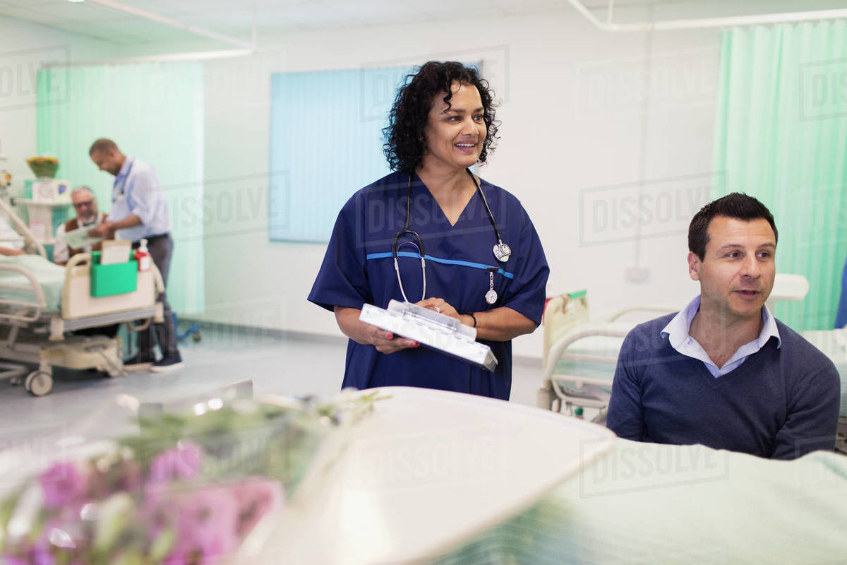 Doctor with medical chart making rounds in hospital ward - Royalty-free ...