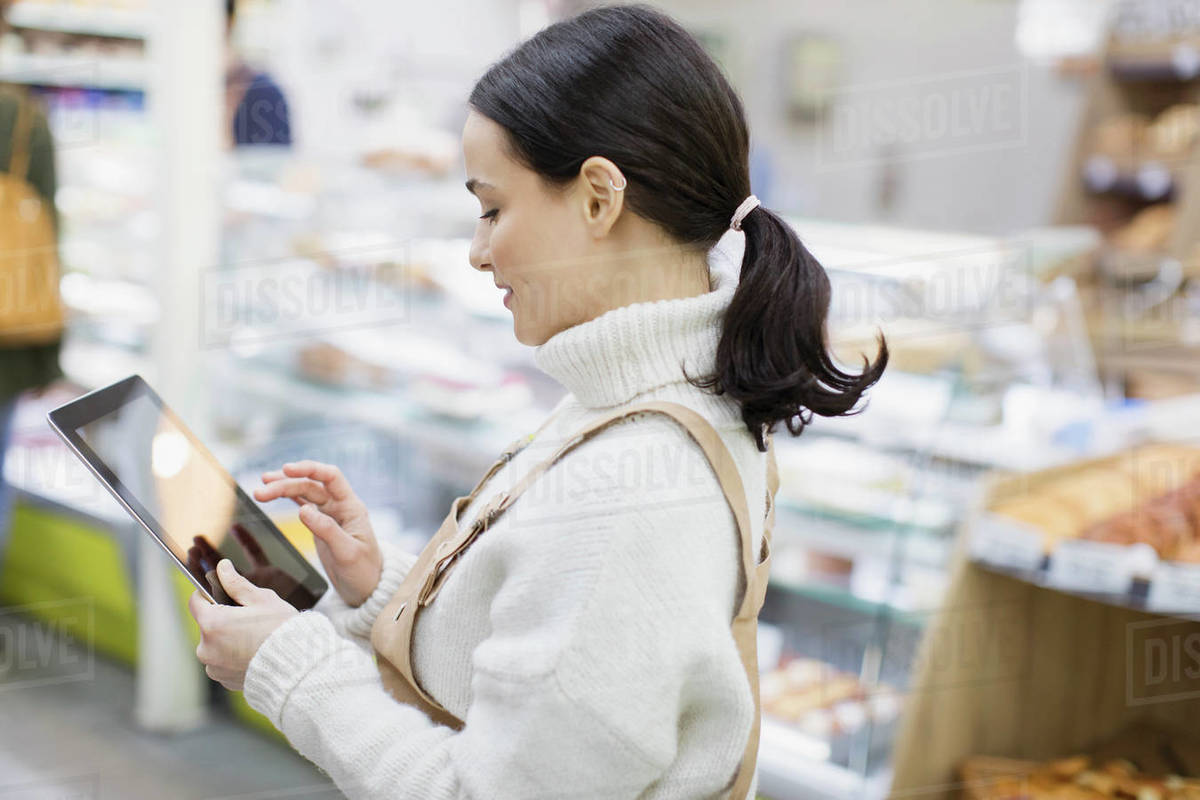 Female grocer with digital tablet working in supermarket - Stock Photo ...