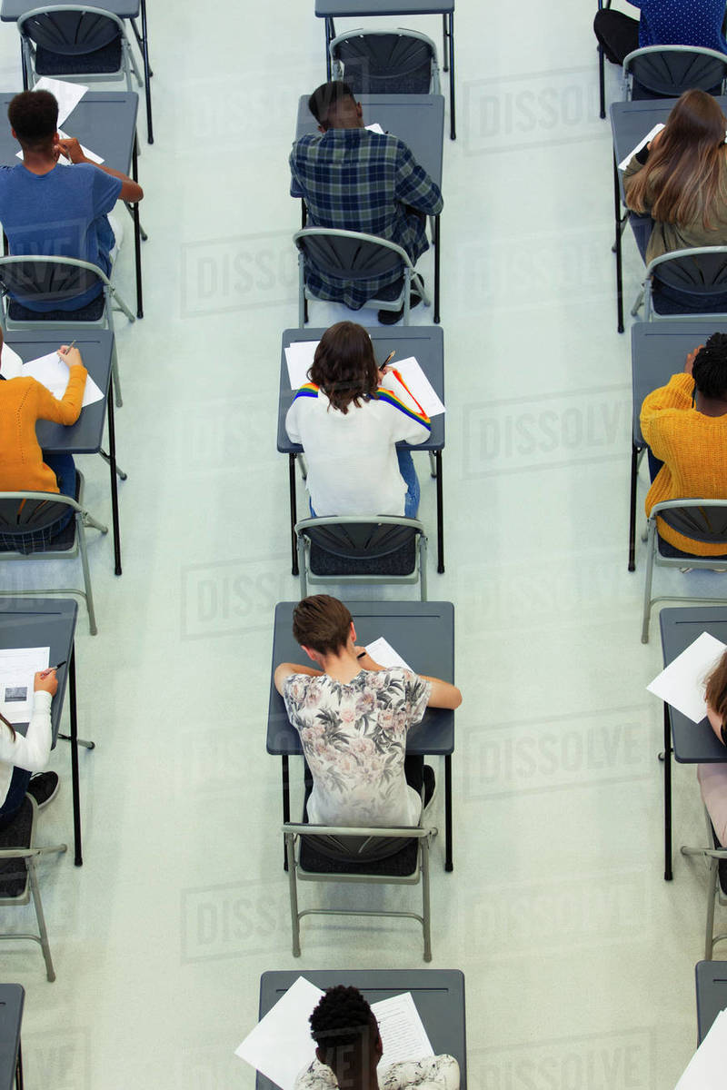 View from above high school students taking exam at desks in classroom ...