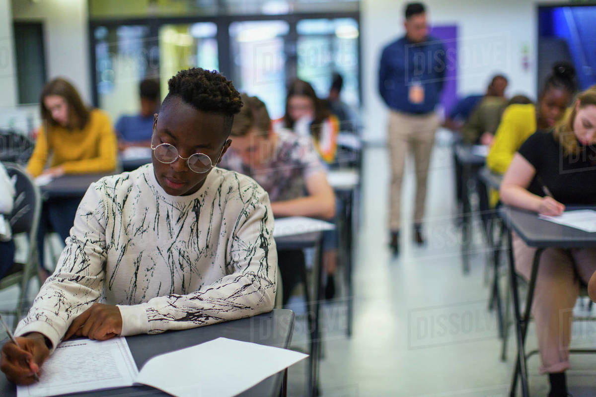 Focused high school boy student taking exam at desk - Stock Photo ...