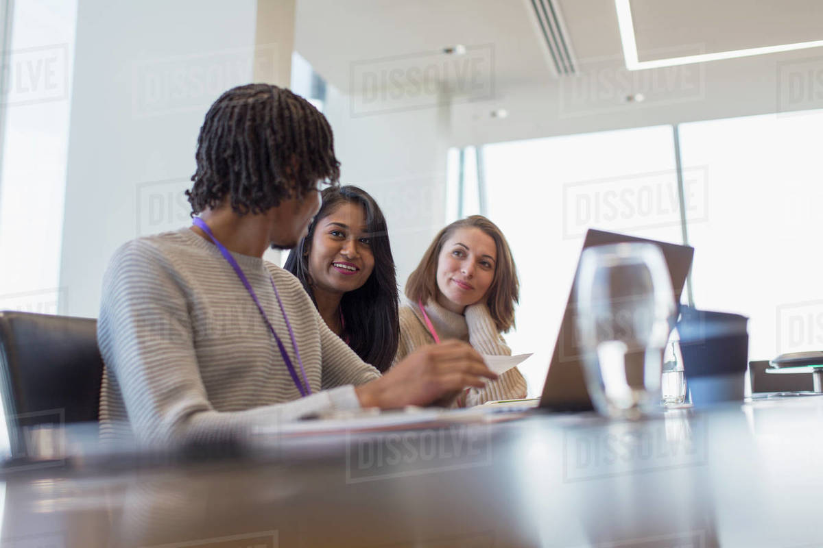 Business people talking at laptop in conference room meeting - Royalty ...
