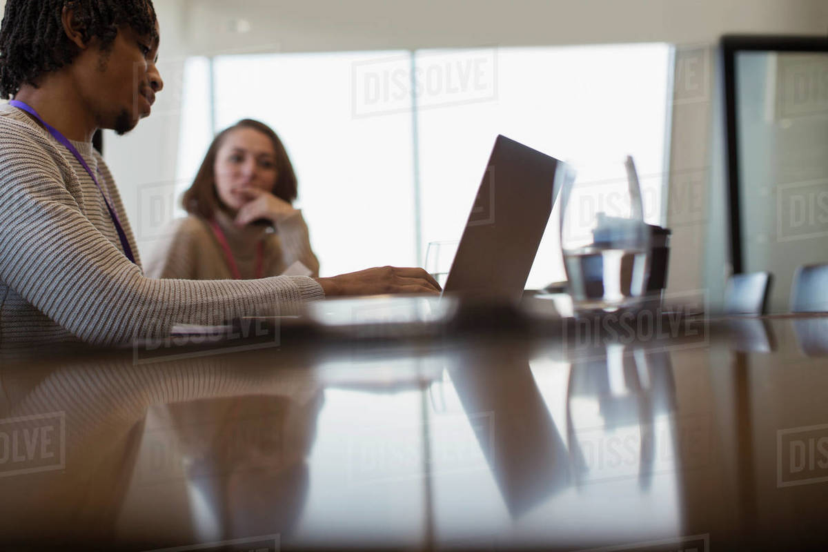 Business people planning at laptop in conference room meeting - Royalty ...