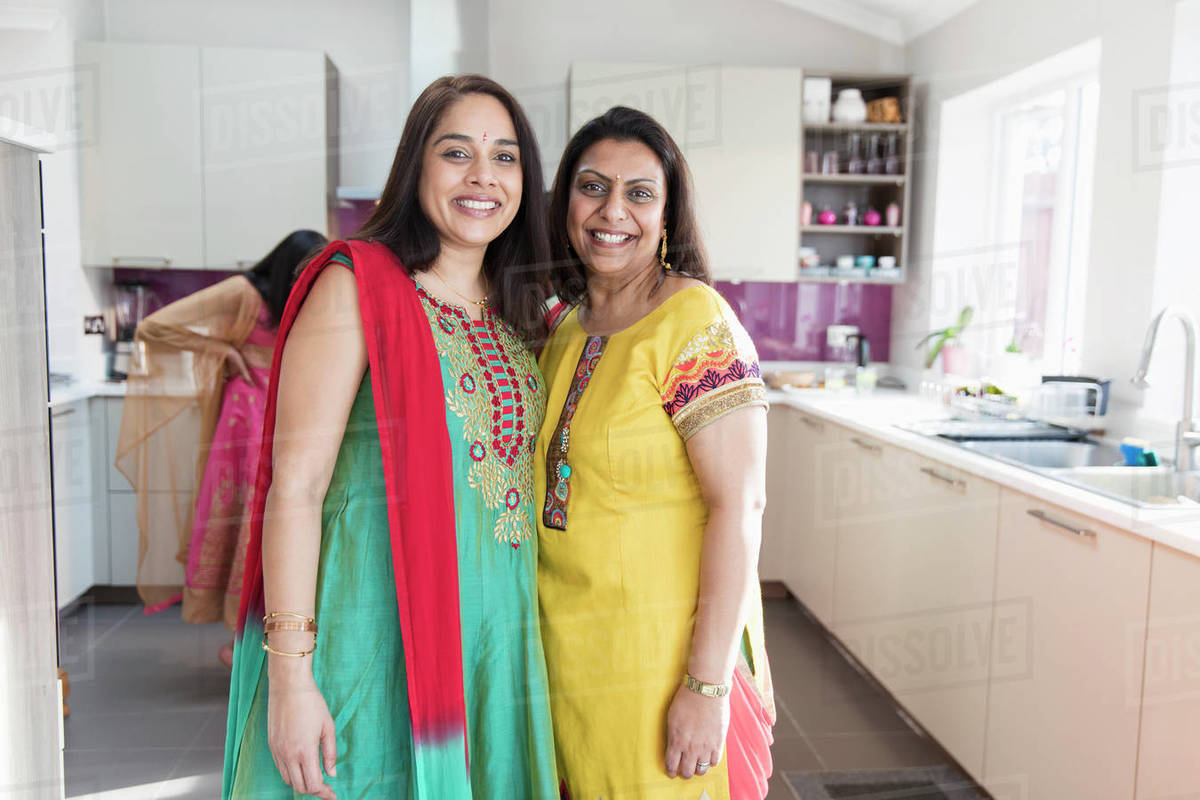 Portrait happy Indian sisters in traditional saris in kitchen - Royalty ...