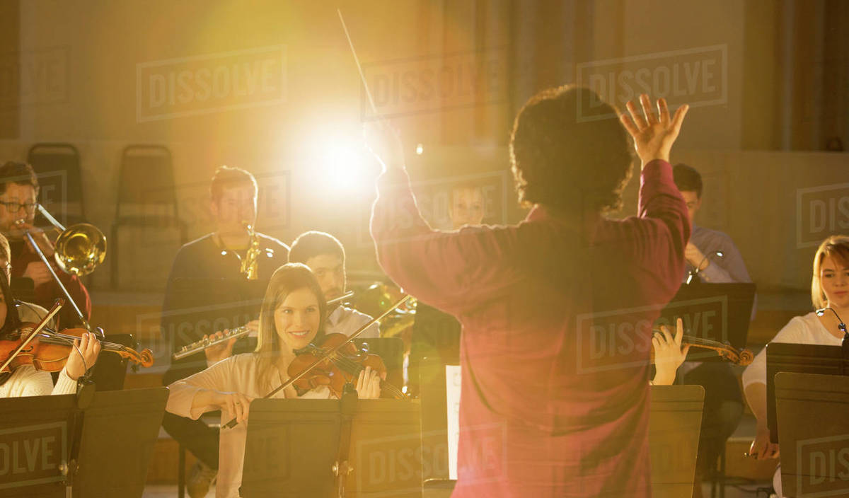 Conductor leading orchestra - Royalty-free Stock Photo | Dissolve