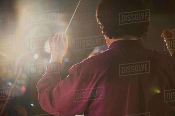 Conductor leading orchestra - Stock Photo - Dissolve