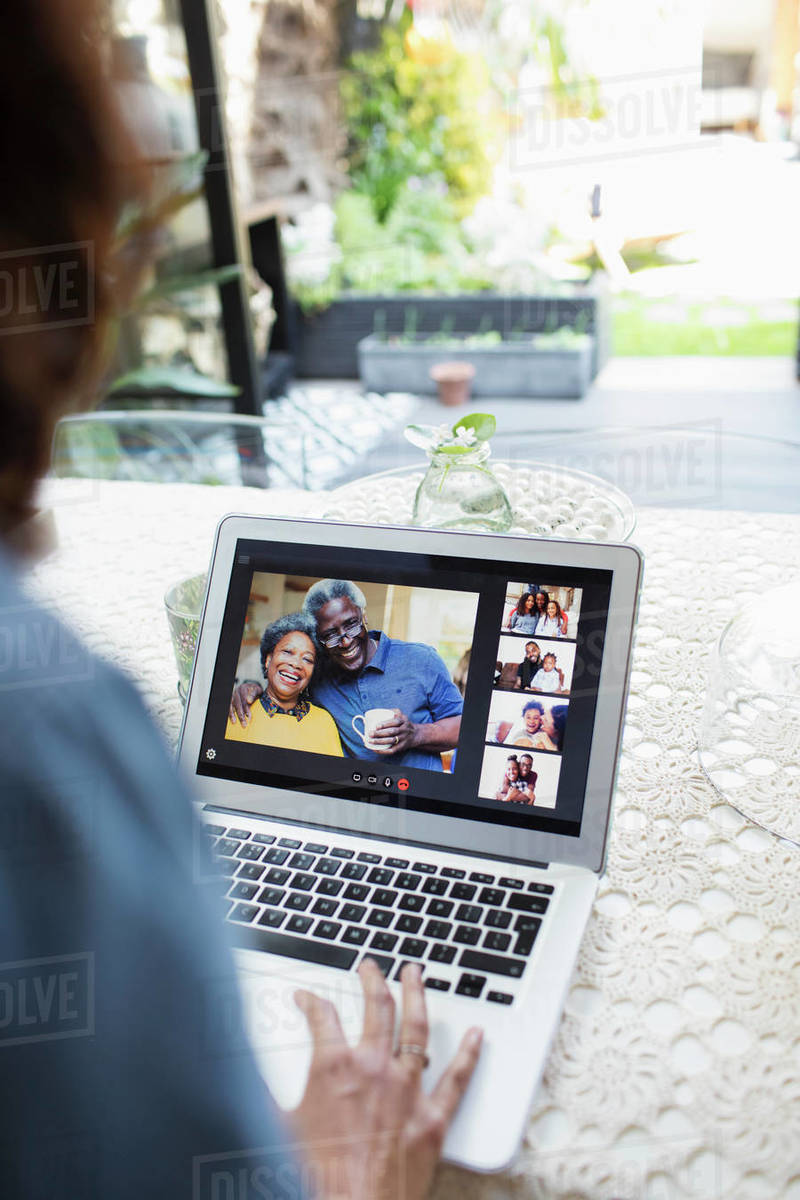 Woman video chatting with family and friends on laptop screen - Stock ...