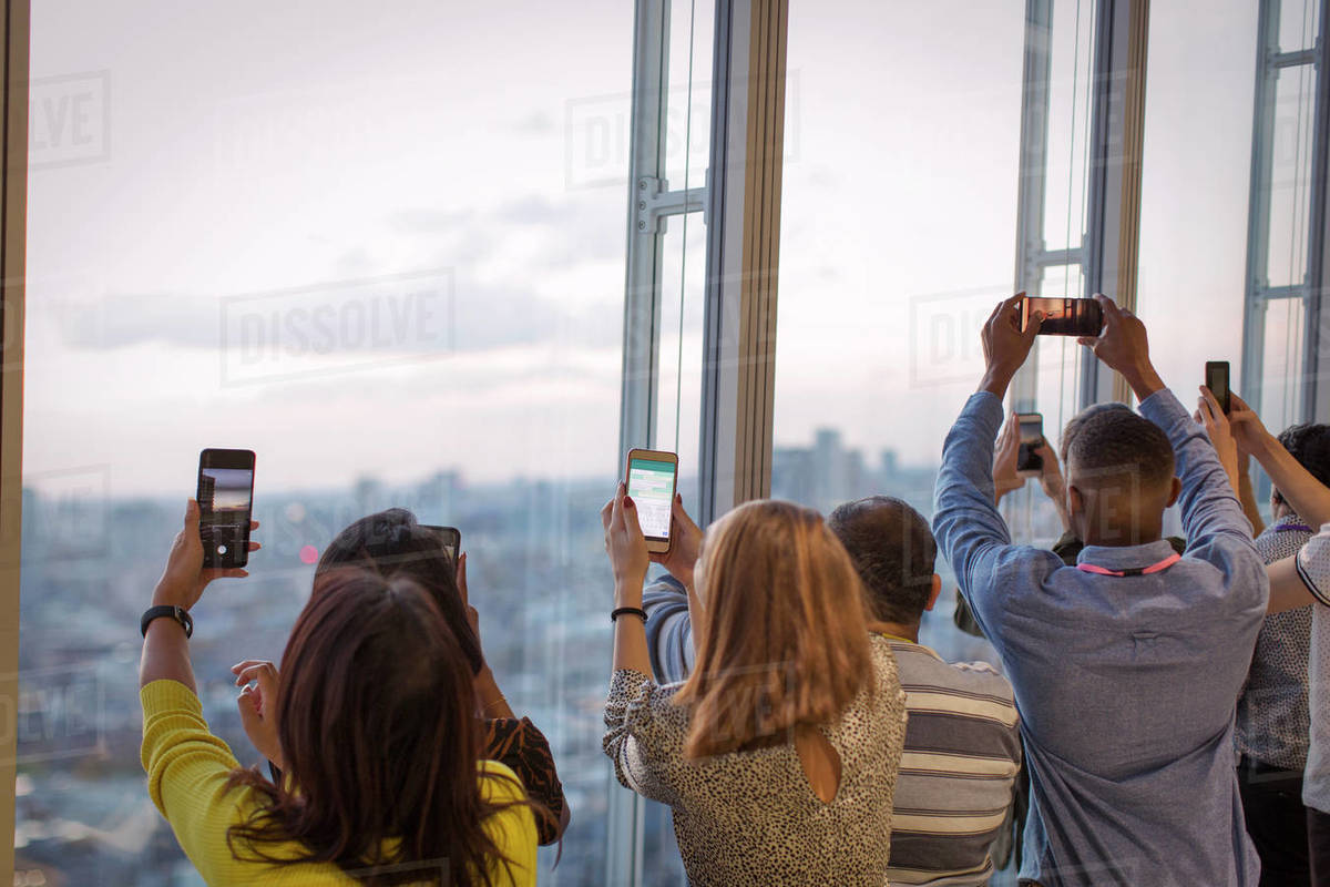 Business people with camera phones photographing city - Royalty-free ...