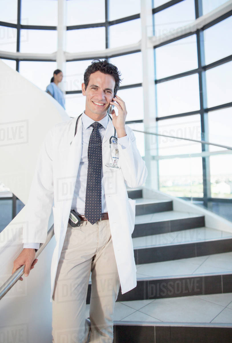 Doctor talking on cell phone in hospital - Royalty-free Stock Photo ...