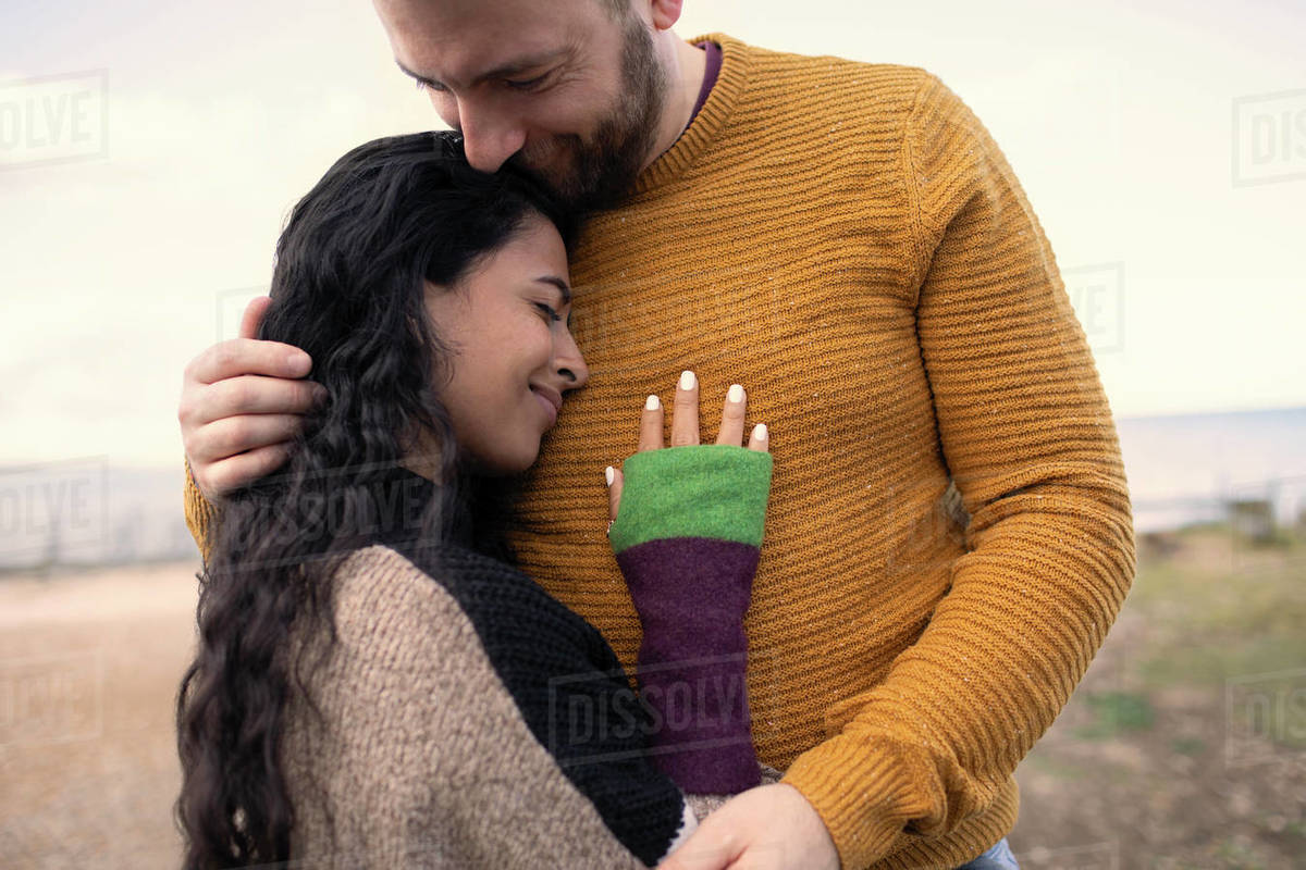 Happy affectionate couple hugging - Stock Photo - Dissolve