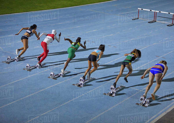 Female track and field athletes at starting blocks - Royalty-free Stock ...