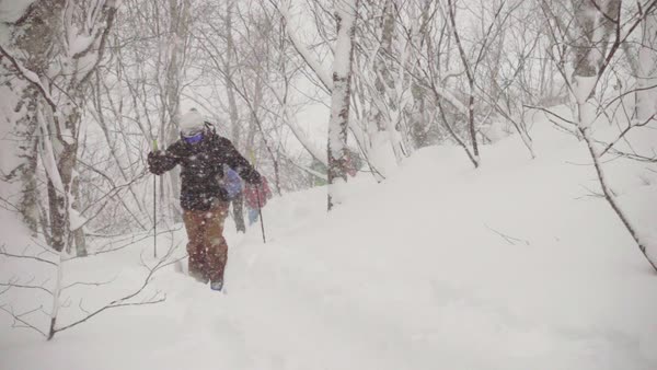 Slow motion of skiers trudging through snow - Stock Video Footage ...