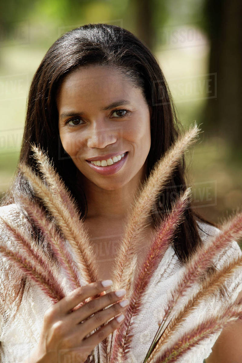 Woman holding reeds - Stock Photo - Dissolve