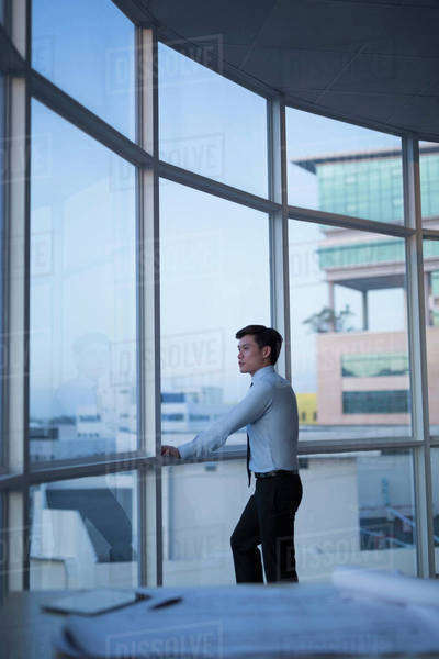 Architect leaning against window - Stock Photo - Dissolve