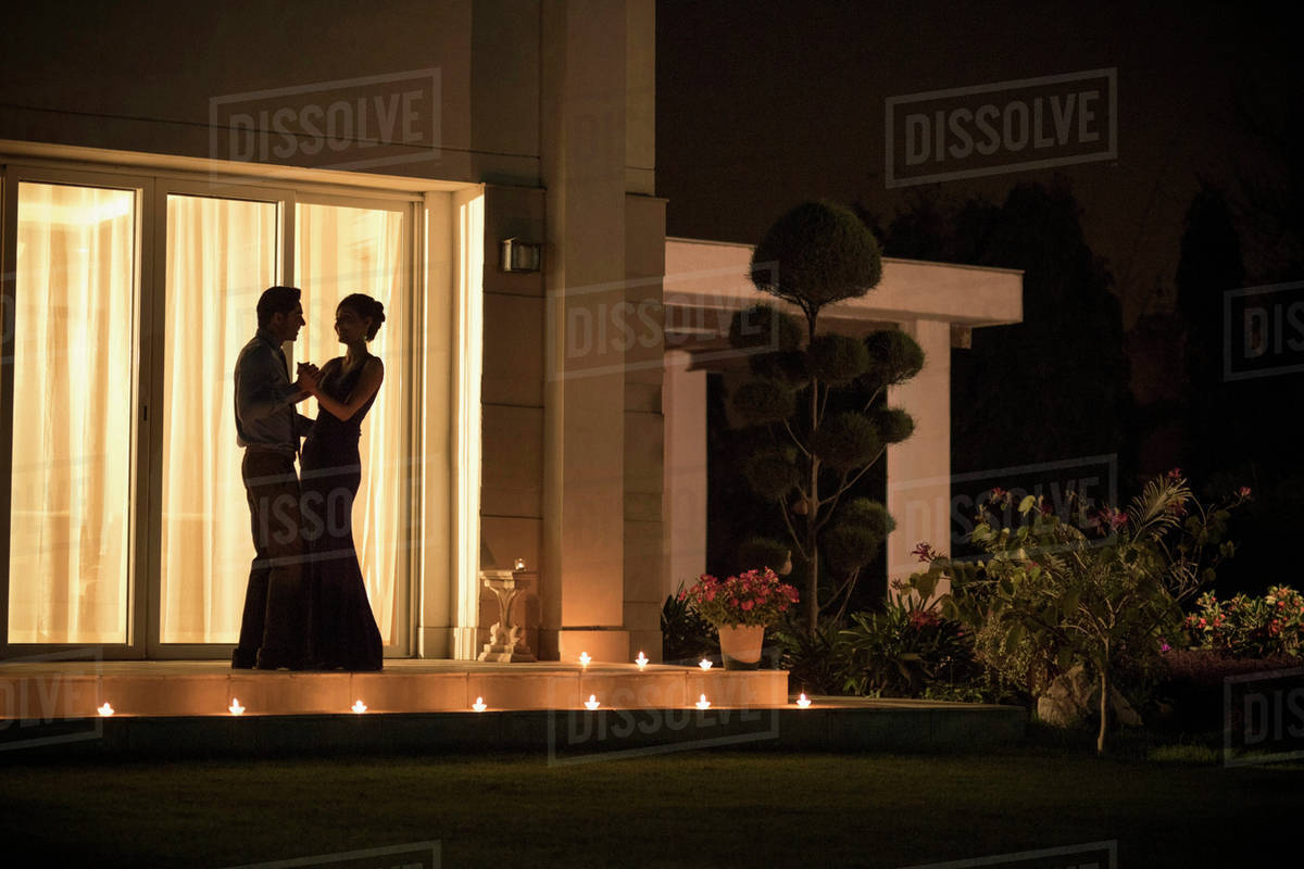 Man and woman in evening wear dancing outside at night - Royalty-free ...