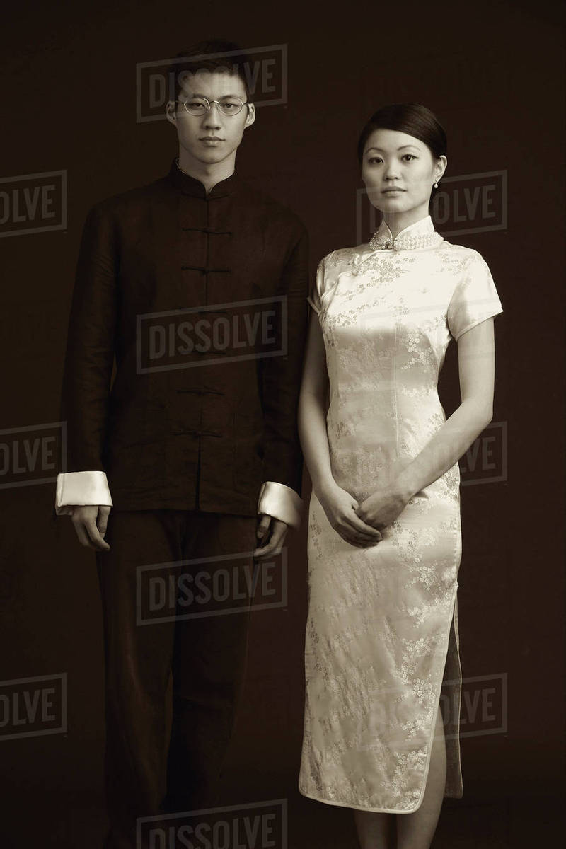 Man and woman dressed in traditional Chinese attire, posing for studio ...