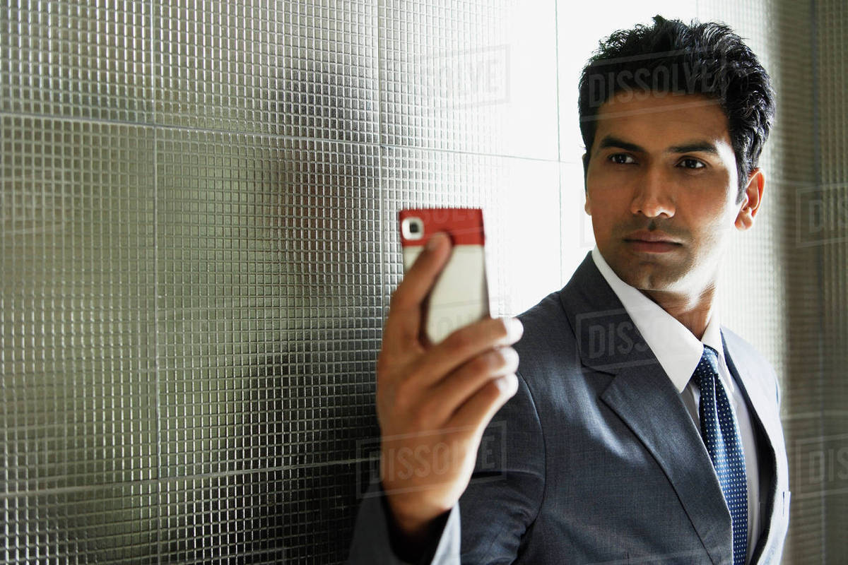 Businessman using mobile phone - Royalty-free Stock Photo | Dissolve