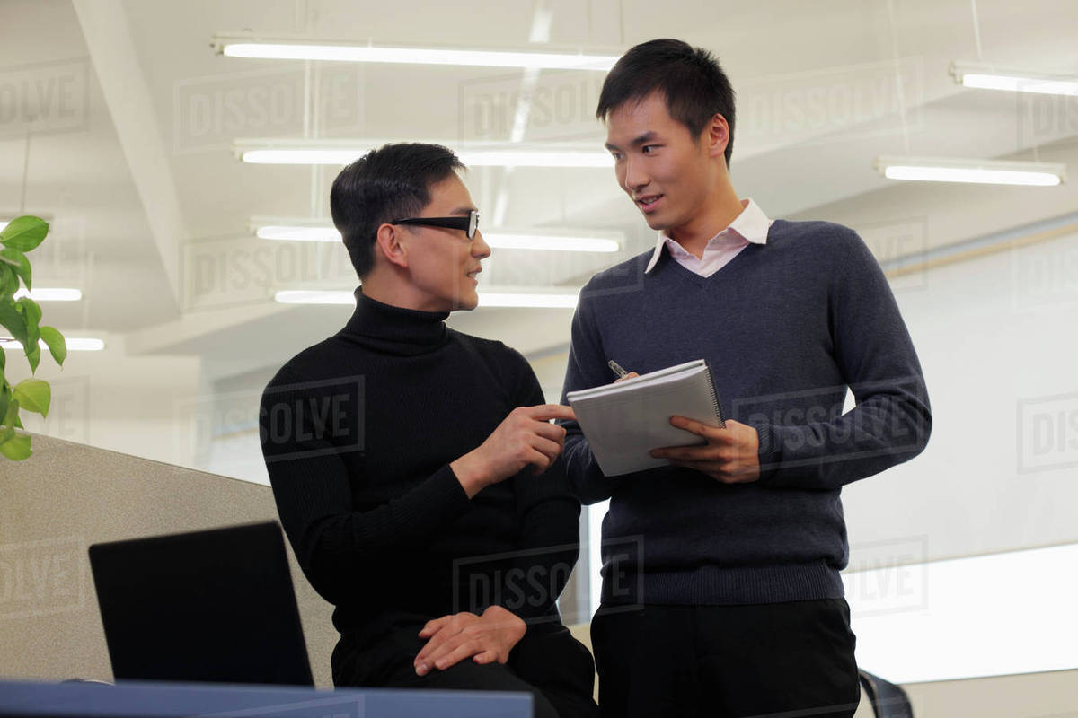 Two men working together in an office - Royalty-free Stock Photo | Dissolve