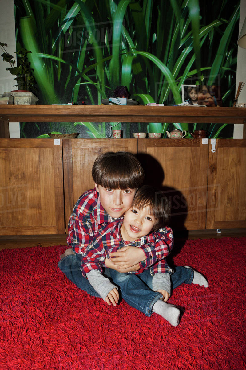 Two brothers in matching outfits embracing - Royalty-free Stock Photo ...