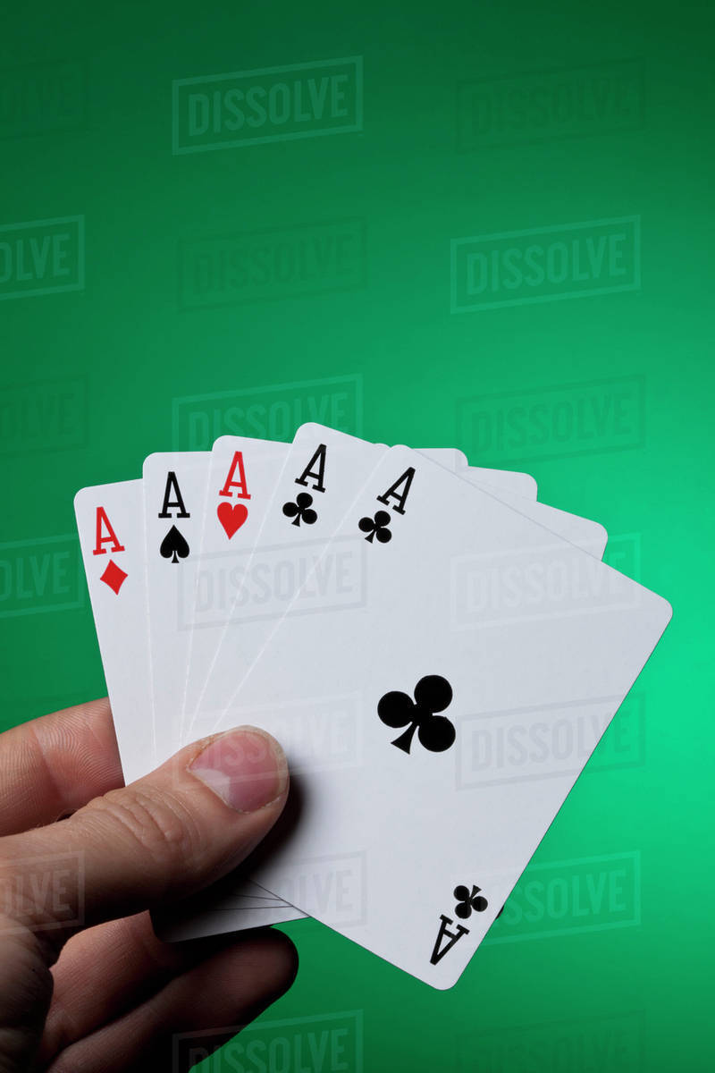 A hand holding five aces fanned out - Royalty-free Stock Photo | Dissolve