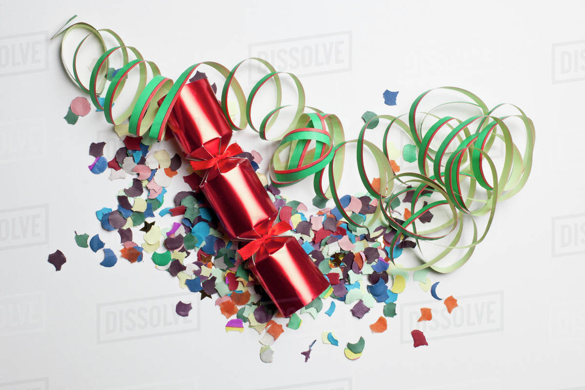 Confetti, streamers and a Christmas cracker - Stock Photo - Dissolve
