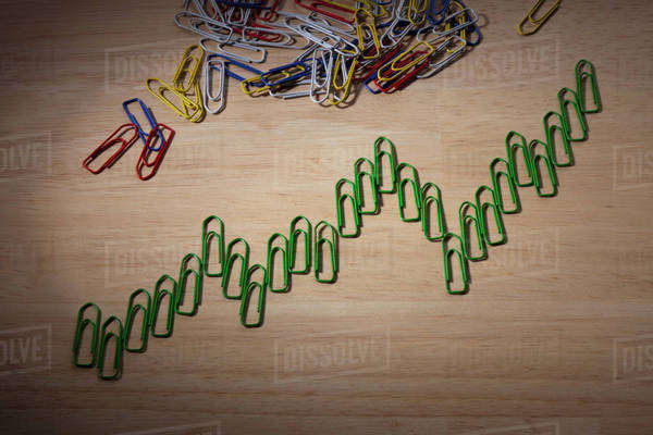 Green paperclips arranged to look like a line in a line graph - Stock ...