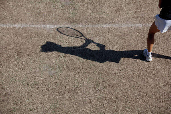 Shadow of tennis player - Stock Photo - Dissolve