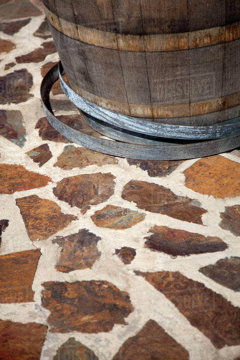 Barrel on paving stone floor - Stock Photo - Dissolve