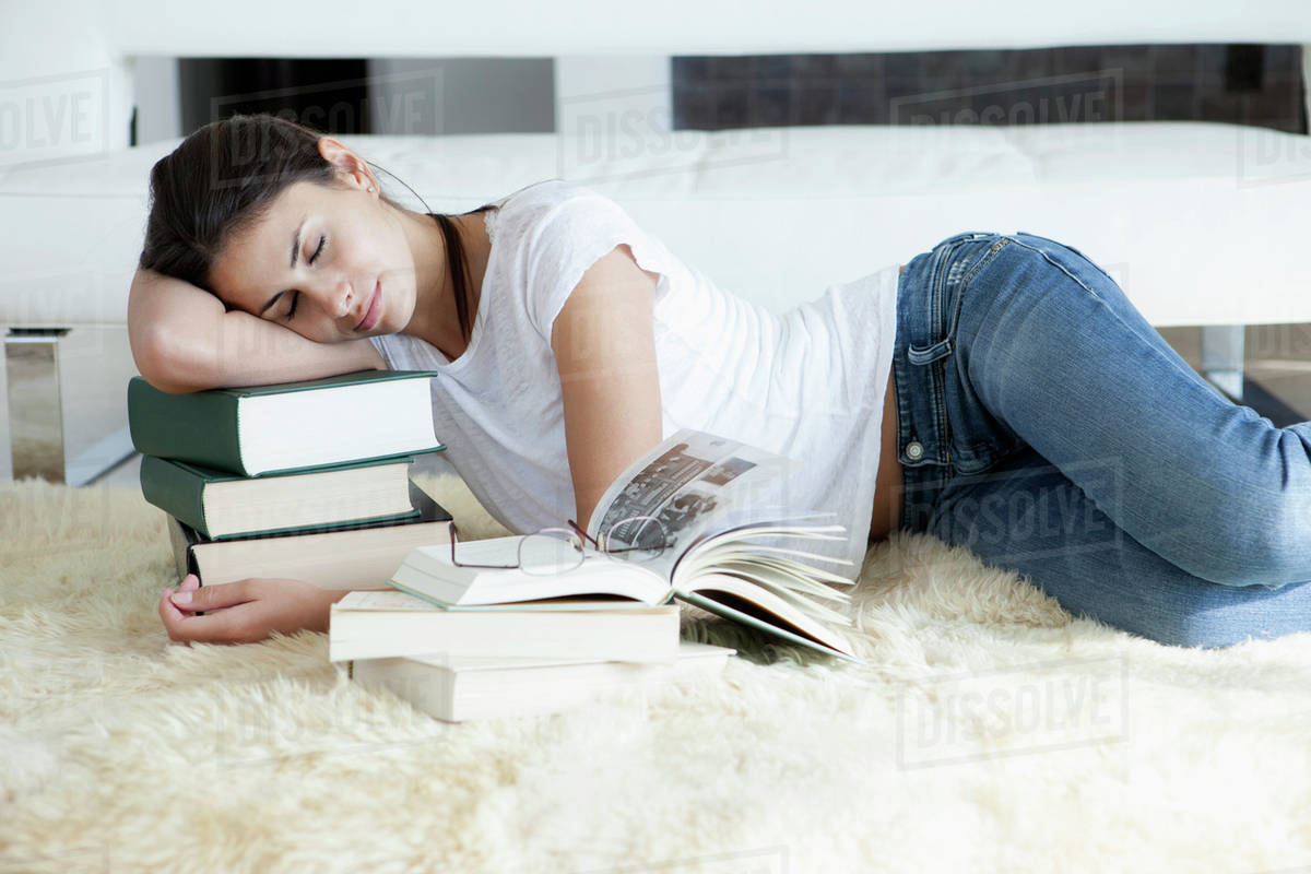 Woman sleeping on her books - Royalty-free Stock Photo | Dissolve