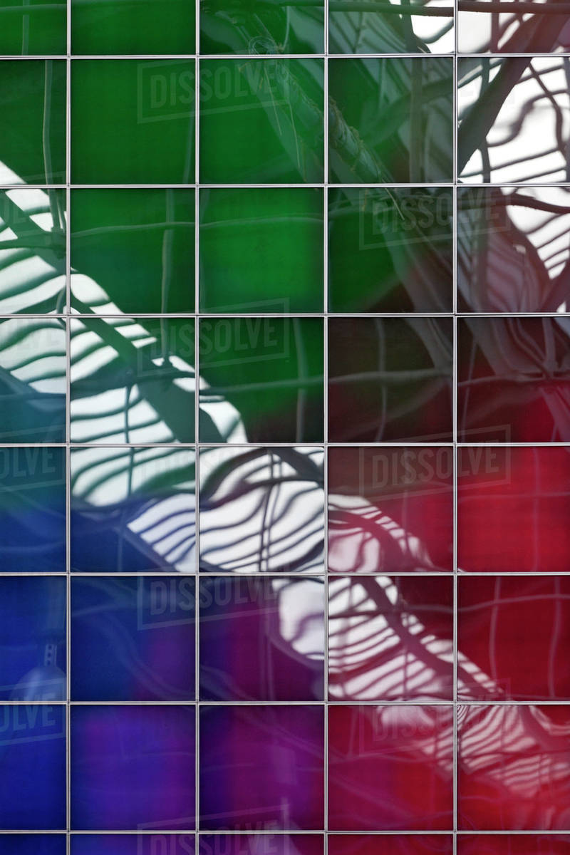 A spectrum of colors reflecting in square glass windows, full frame ...