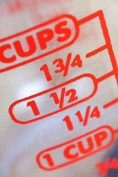 Fraction measurements on the side of a liquid measuring cup, extreme ...