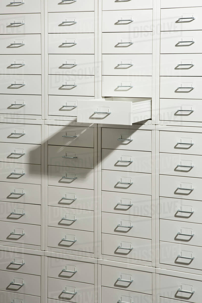 A white cabinet of drawers with one drawer open - Royalty-free Stock ...