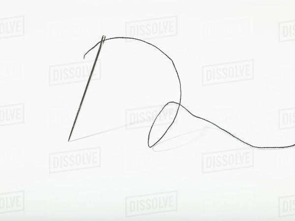 A threaded needle standing up - Stock Photo - Dissolve
