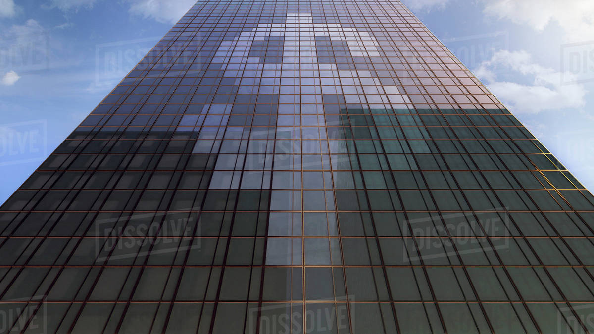 A dollar sign on the windows of an office building, low angle view ...