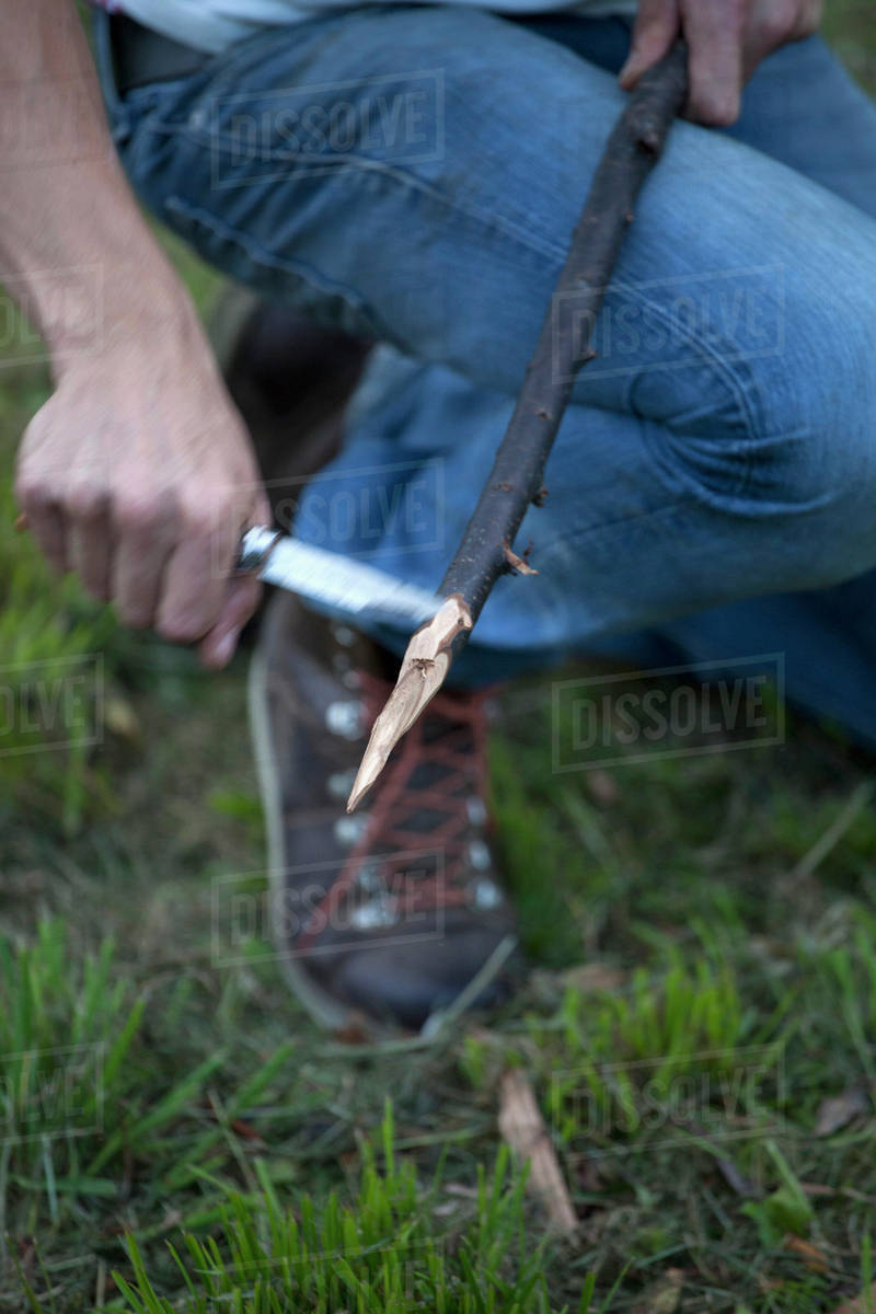 Man cutting stick with knife, close-up - Royalty-free Stock Photo ...