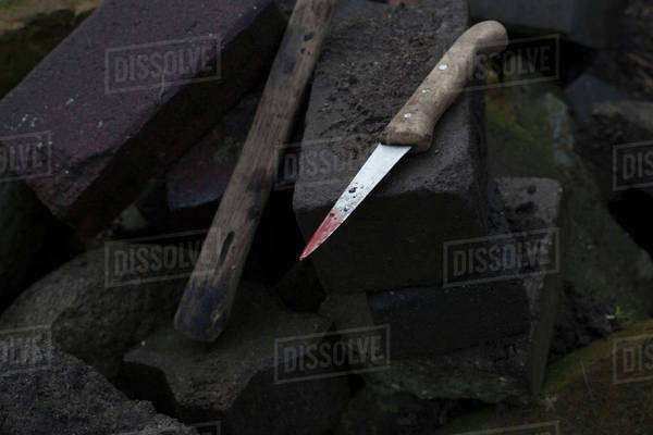 High angle view of blood stained knife on bricks - Royalty-free Stock ...
