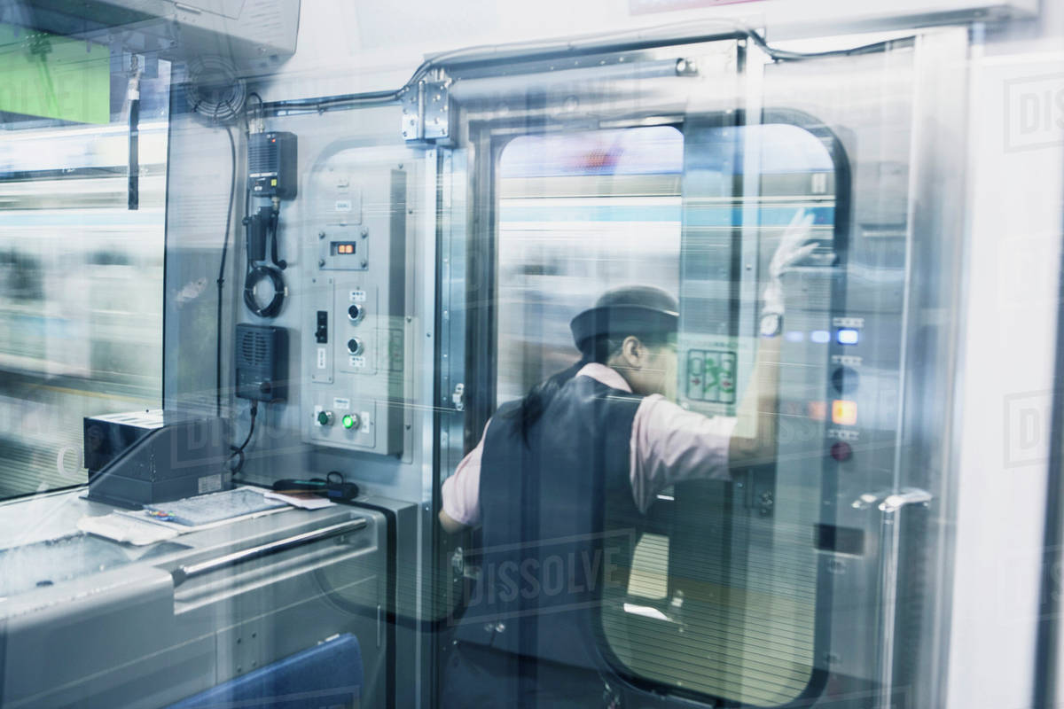 Rear view of female train engineer looking through window - Stock Photo ...