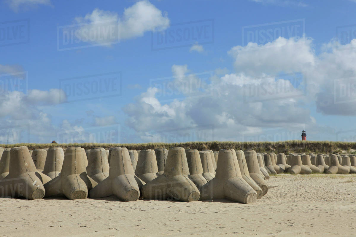 Tetrapod rocks arranged on sandy beach against sky - Royalty-free Stock ...