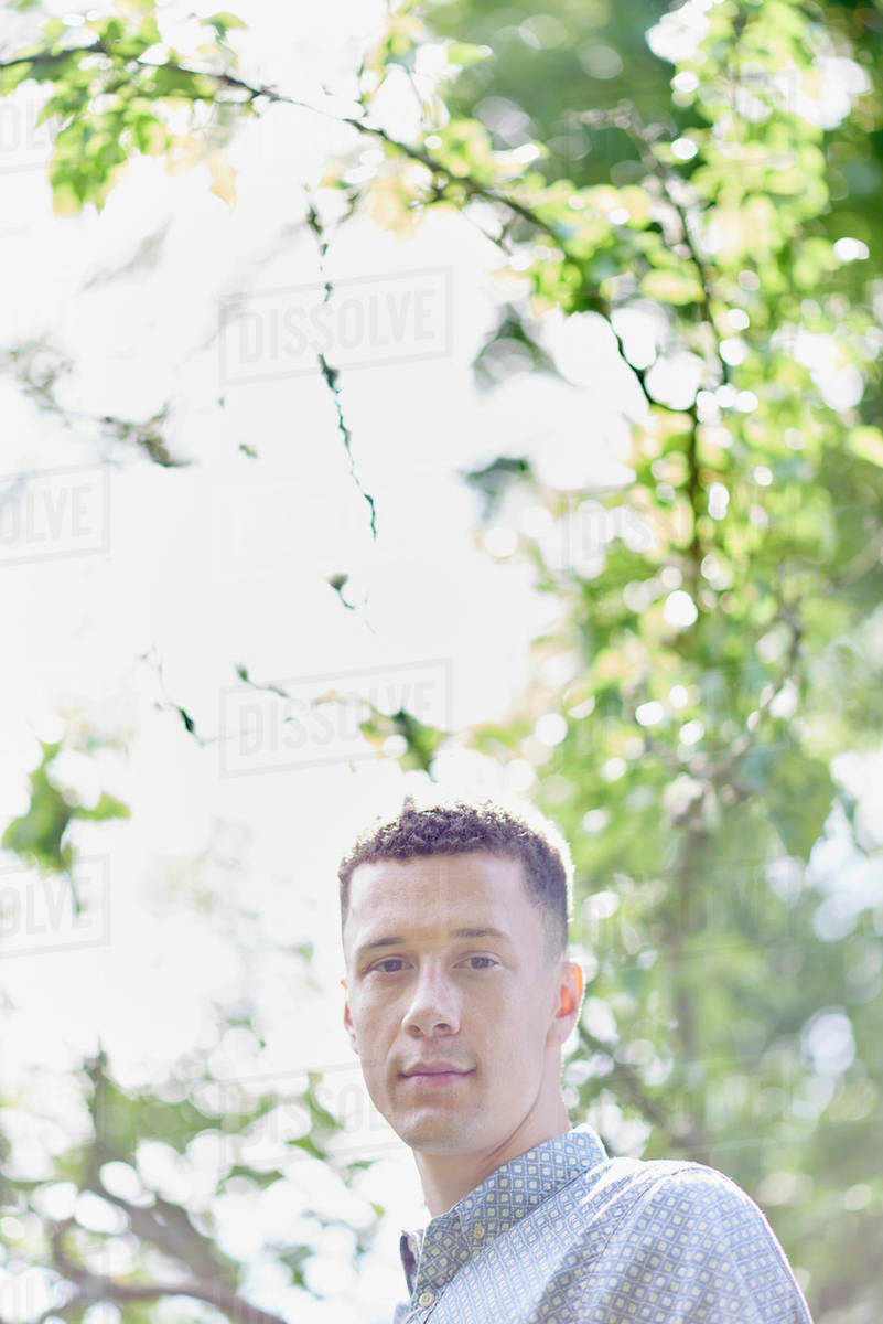 Low angle portrait of young man in park - Royalty-free Stock Photo ...