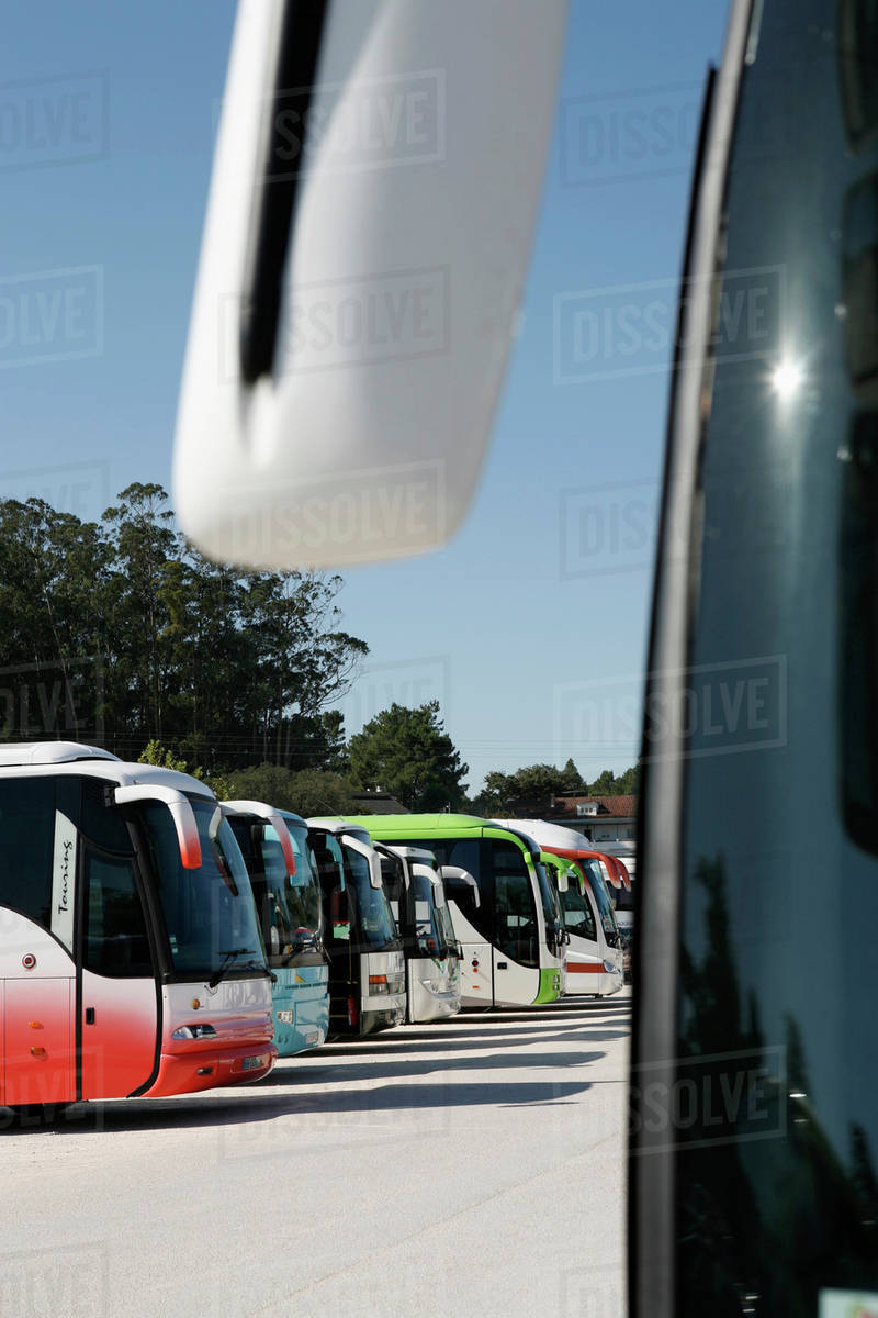Coach buses parked in a row - Stock Photo - Dissolve