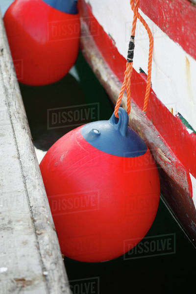 Boat bumpers tied to a boat docked at a jetty - Stock Photo - Dissolve