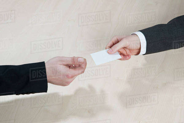 Businessmen pass the card - Stock Photo - Dissolve