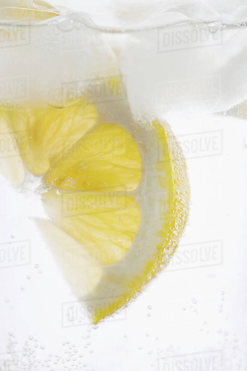 Detail of a slice of lemon in water - Royalty-free Stock Photo | Dissolve