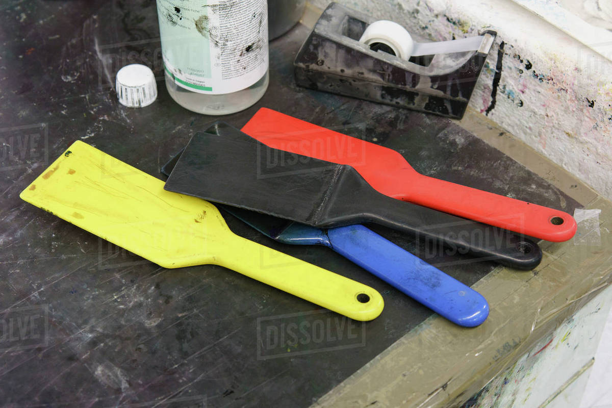 High angle view of tools and adhesive tape on table at printing press ...