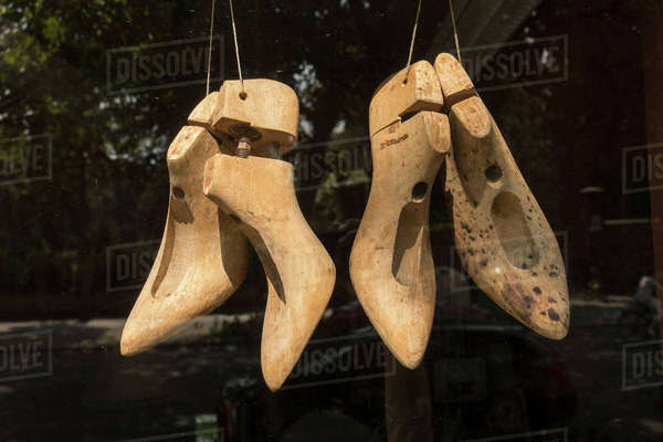 Close-up of wooden high heels sculptures hanging at store - Royalty ...