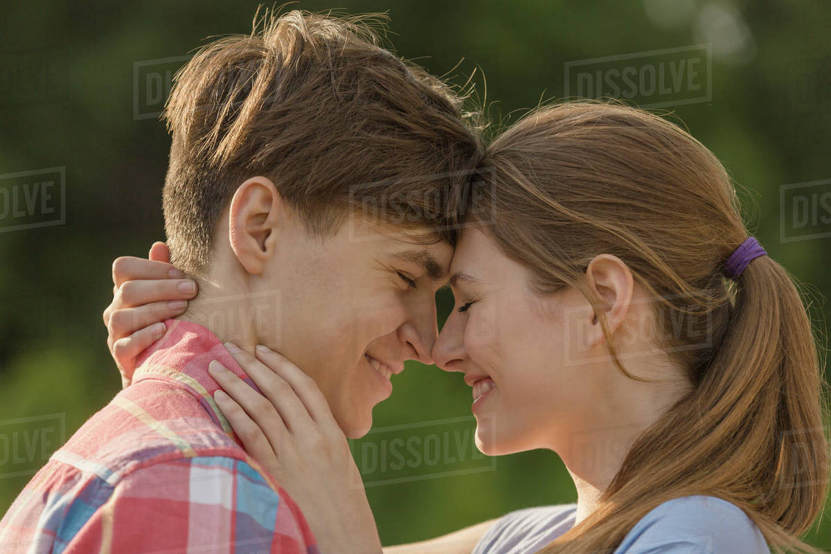 Close-up of romantic loving couple standing face to face with eyes ...