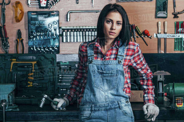 Portrait of female mechanic standing at workshop - Royalty-free Stock ...