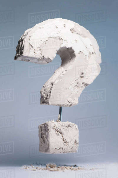 Question mark made of stone material levitating against gray background ...