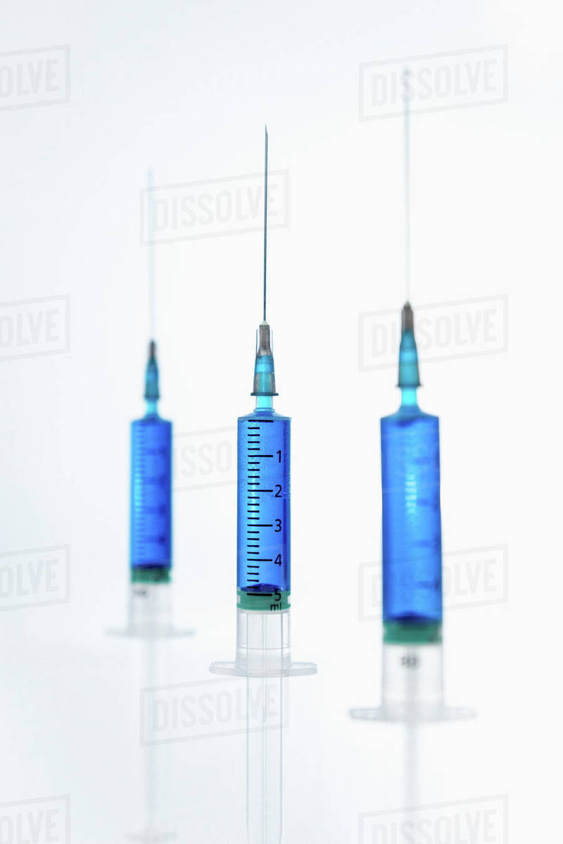 Syringes with blue liquid - Royalty-free Stock Photo | Dissolve